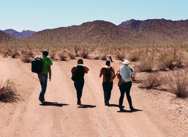 a group of people traveling into desert - Photo #2350118 - AI Generated ...